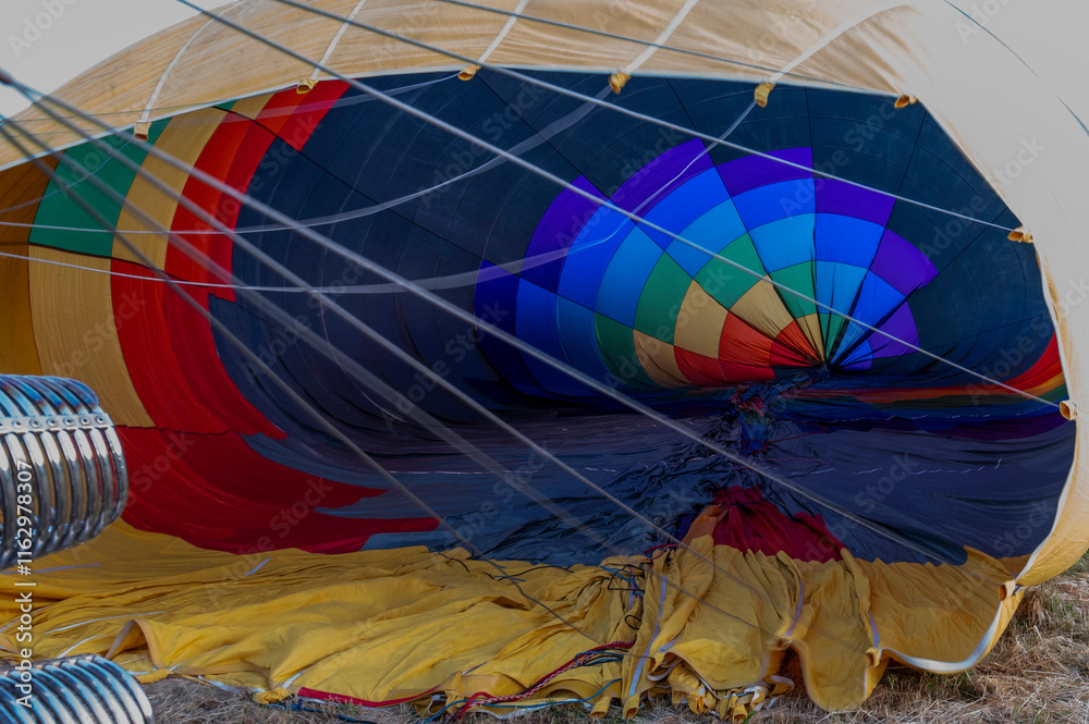 A close-up view of the colorful interior of a deflated hot air balloon ...