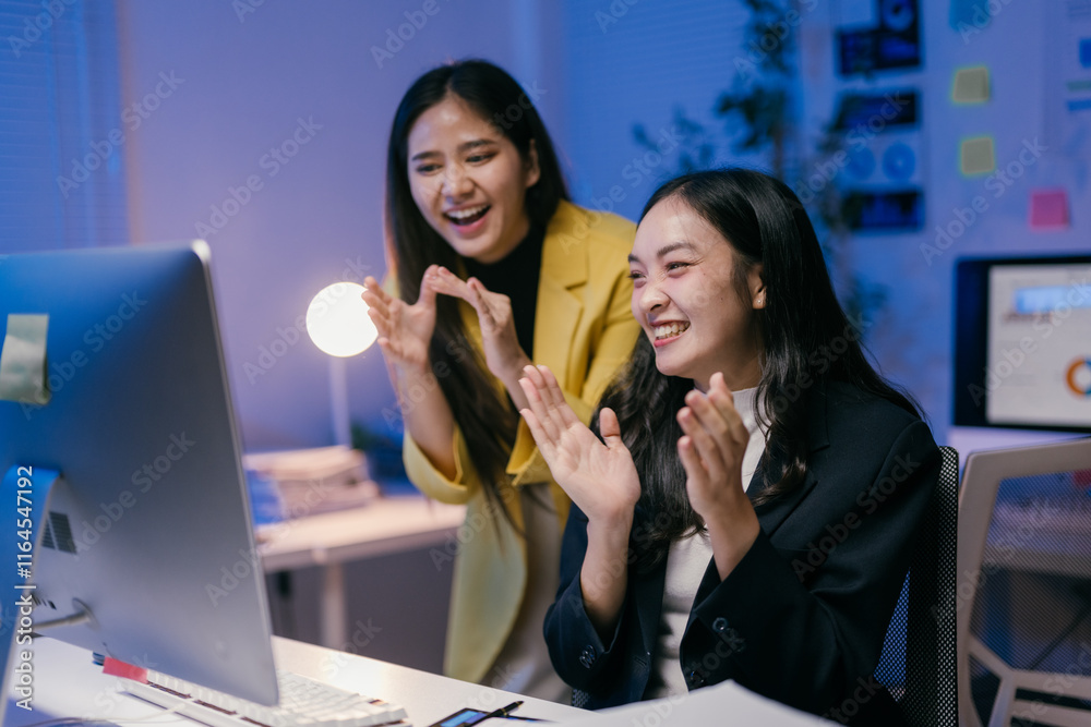 Two excited businesswomen are clapping hands, celebrating successful ...