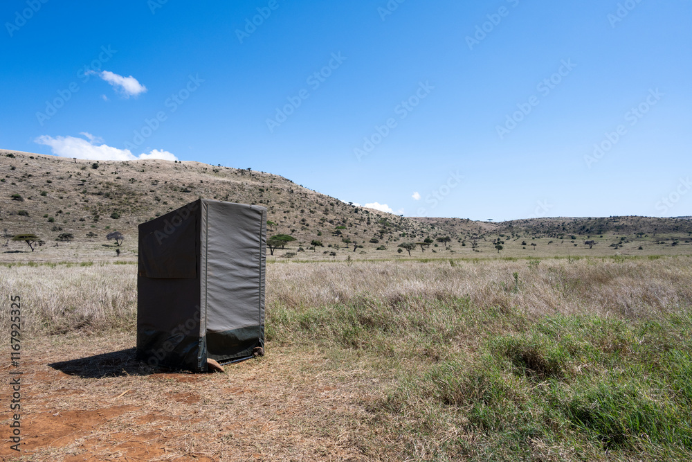 Portable outhouse bathroom set up out in the African bush, dry grass ...