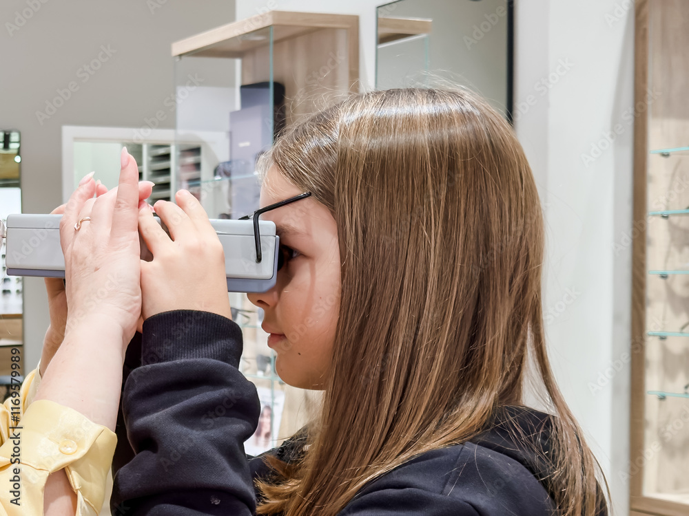Optometrist performing visual test of child. Examination child with ...