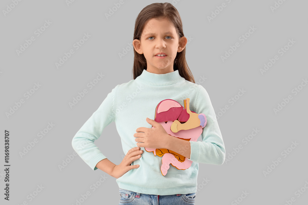 Teenage girl with appendicitis and paper digestive system on light ...