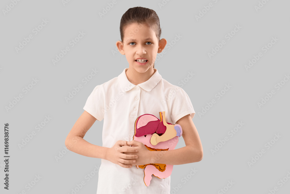 Teenage girl with appendicitis and paper digestive system on light ...
