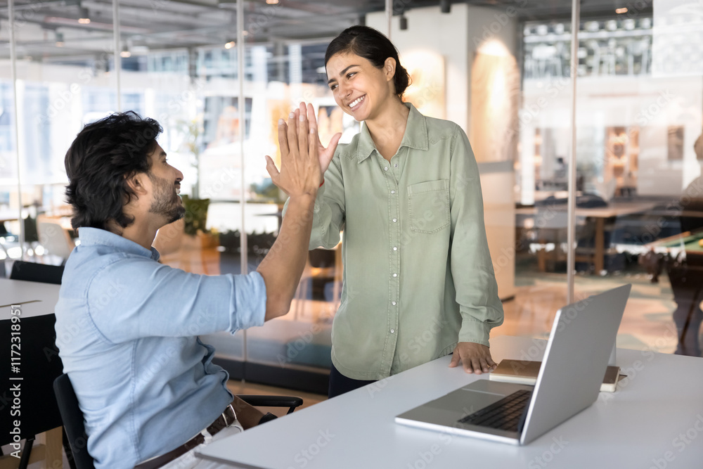 Cheerful successful Indian business colleagues giving high five at ...