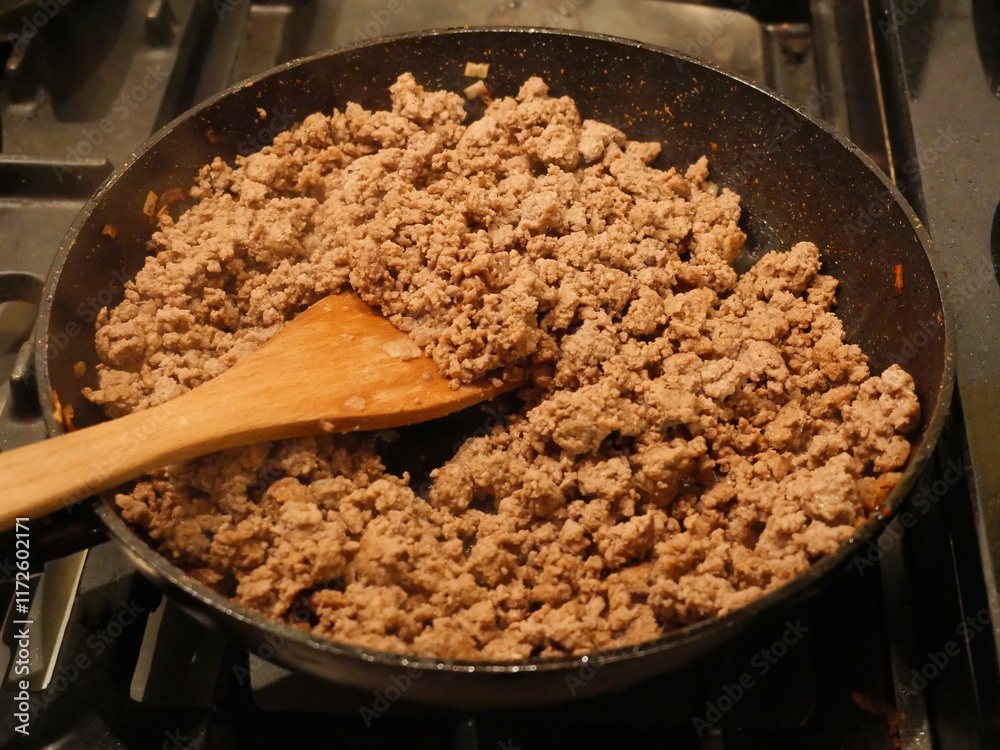 Minced meat fried in the pan.roasted minced meat in close-up. The brown ...
