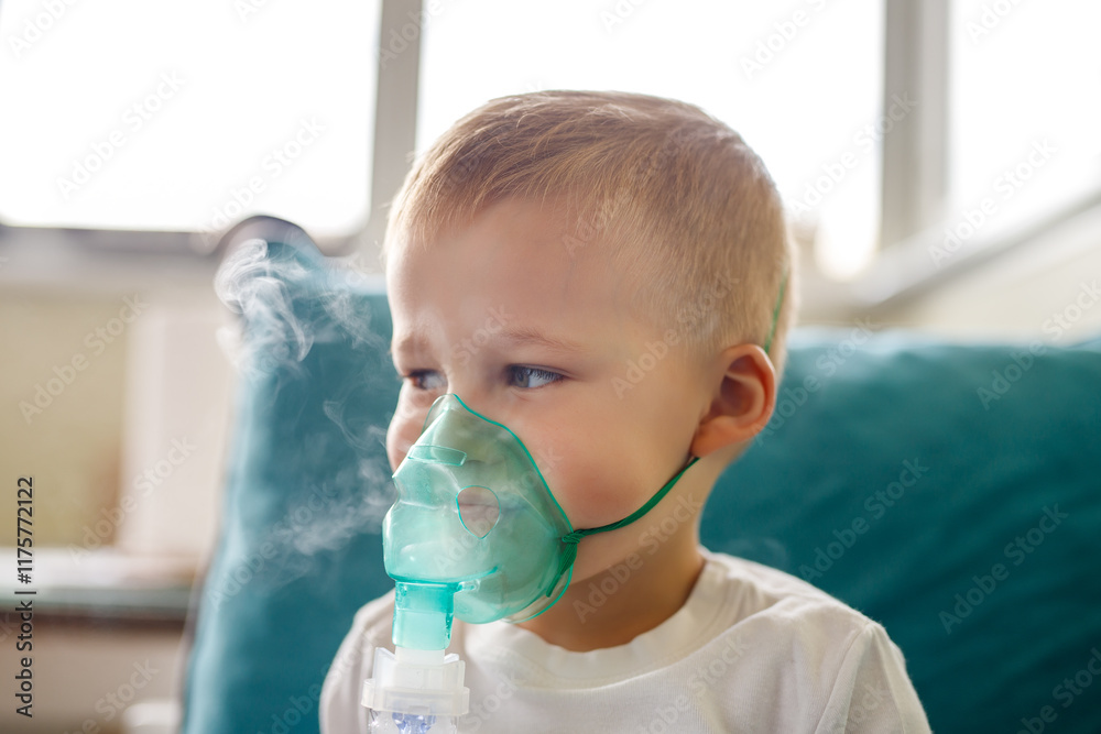 Cute little kid boy wear use medical nebulizer mask inhaling steam ...