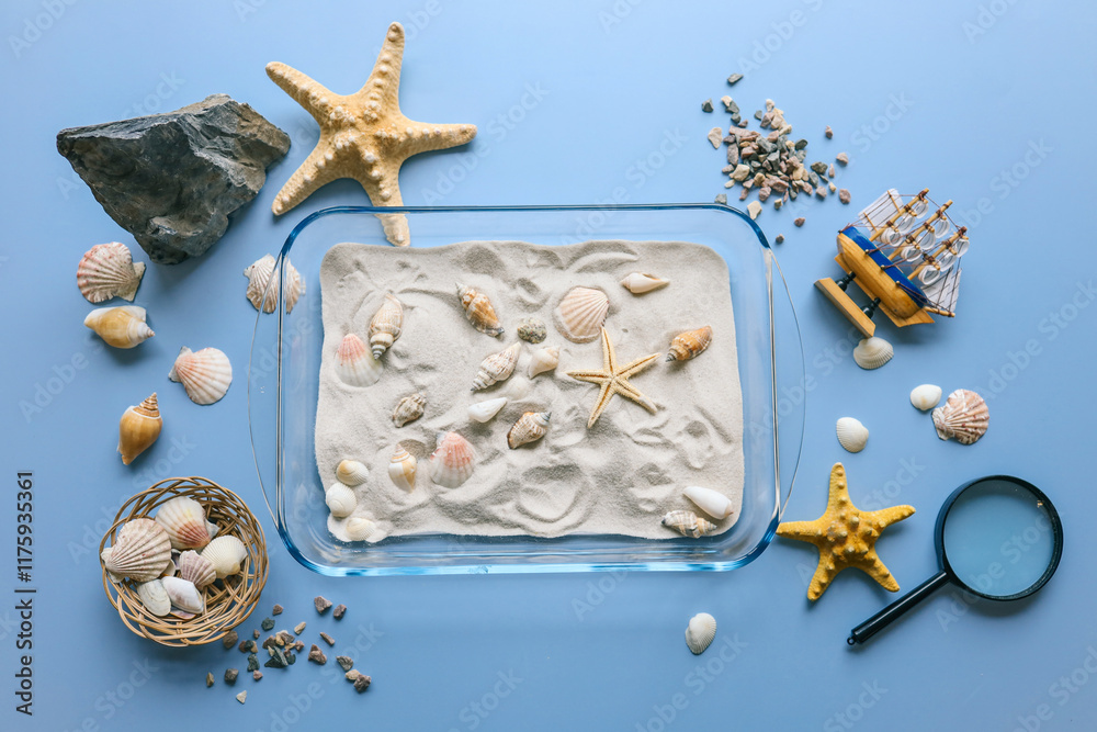 Flat lay of a marine-themed sensory setup featuring a glass dish filled ...