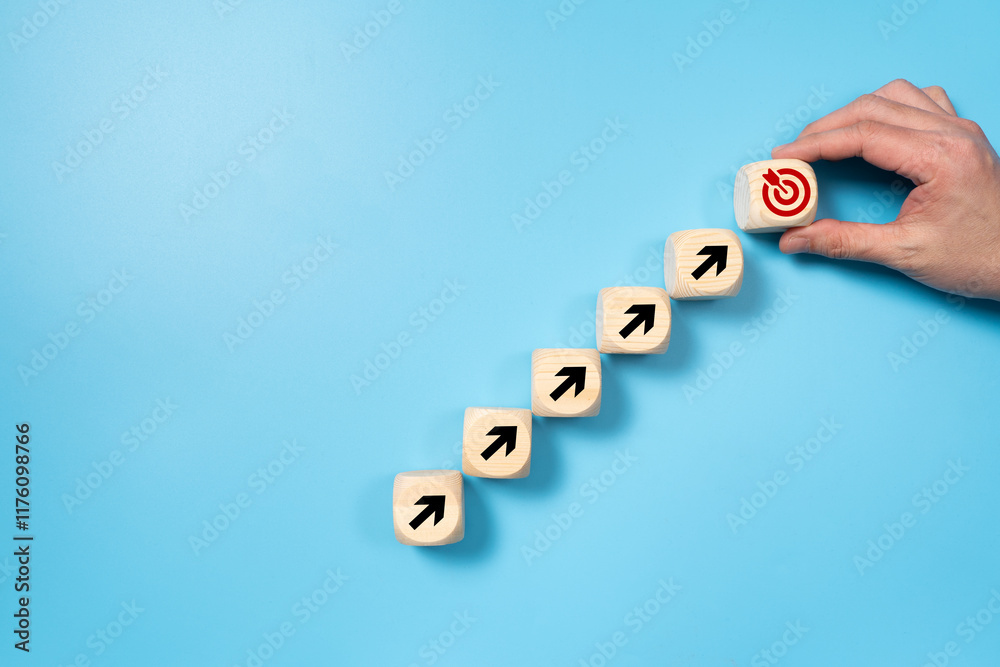 Wooden blocks forming a staircase with upward arrows, leading to a ...