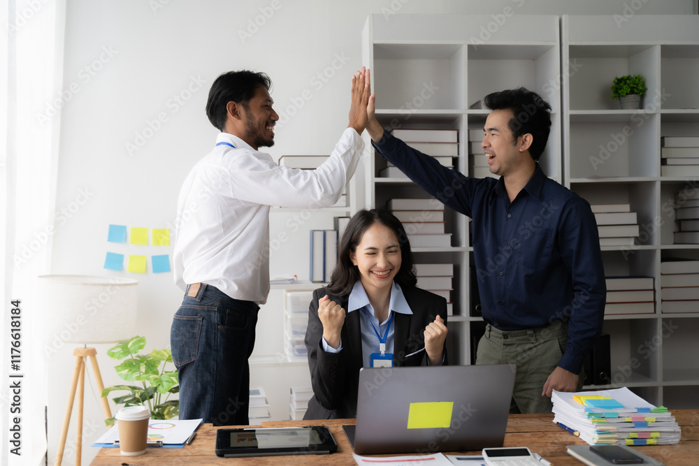 High Five Success: A diverse team celebrates a win with a celebratory ...