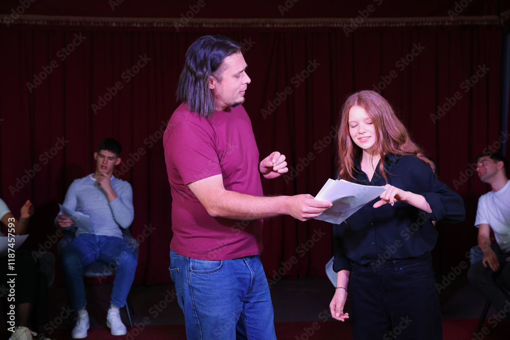 Professional actors with their scripts rehearsing in theatre Stock ...