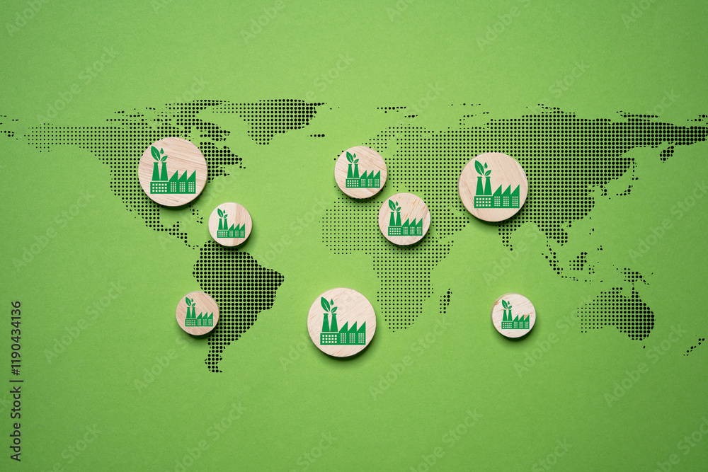 Green factory print screen on wooden block on world map and green background for green economy ...