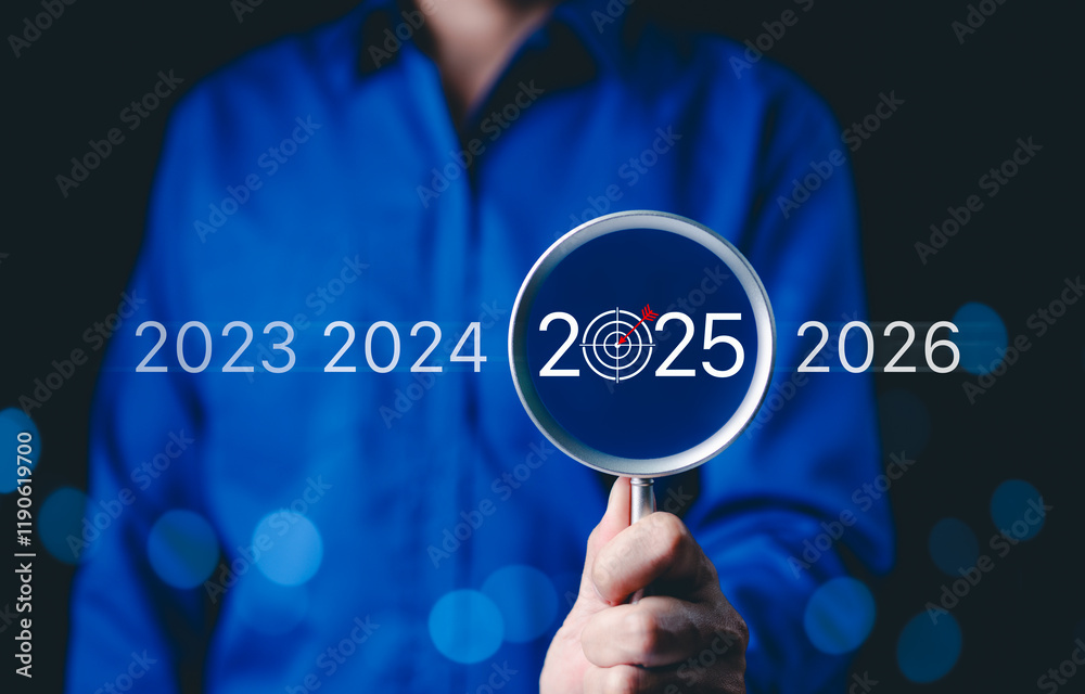 Focus on 2025 Business Goals and Future Planning. A person holding a ...