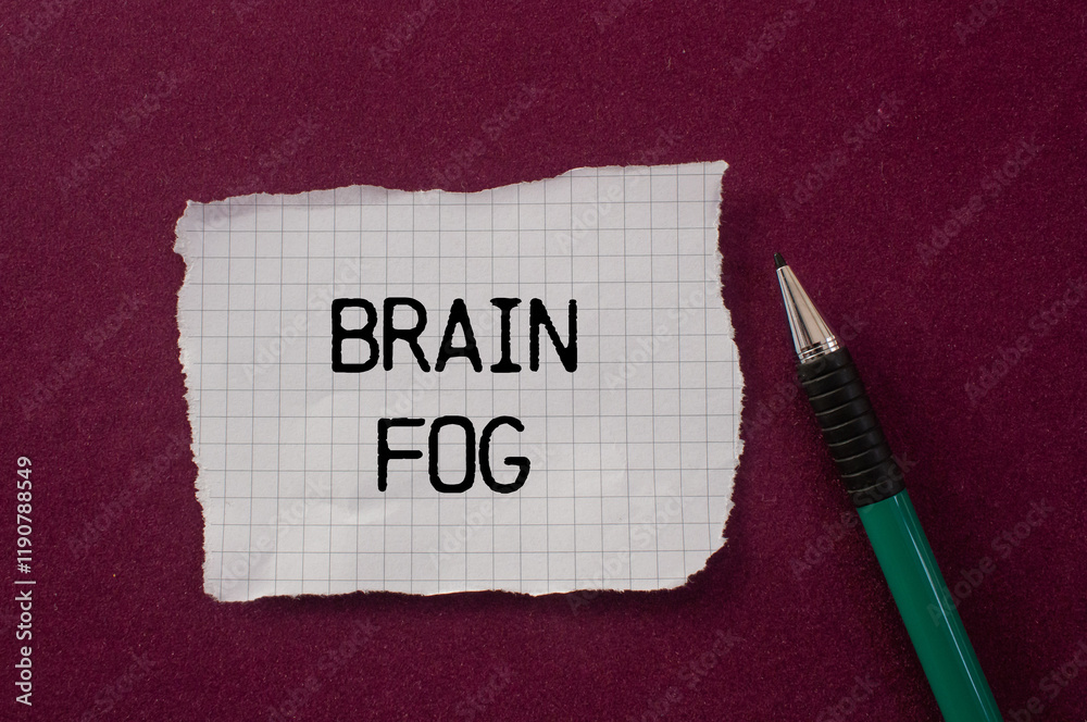 Brain fog message written on ripped torn paper piece with purple background. Conceptual brain ...