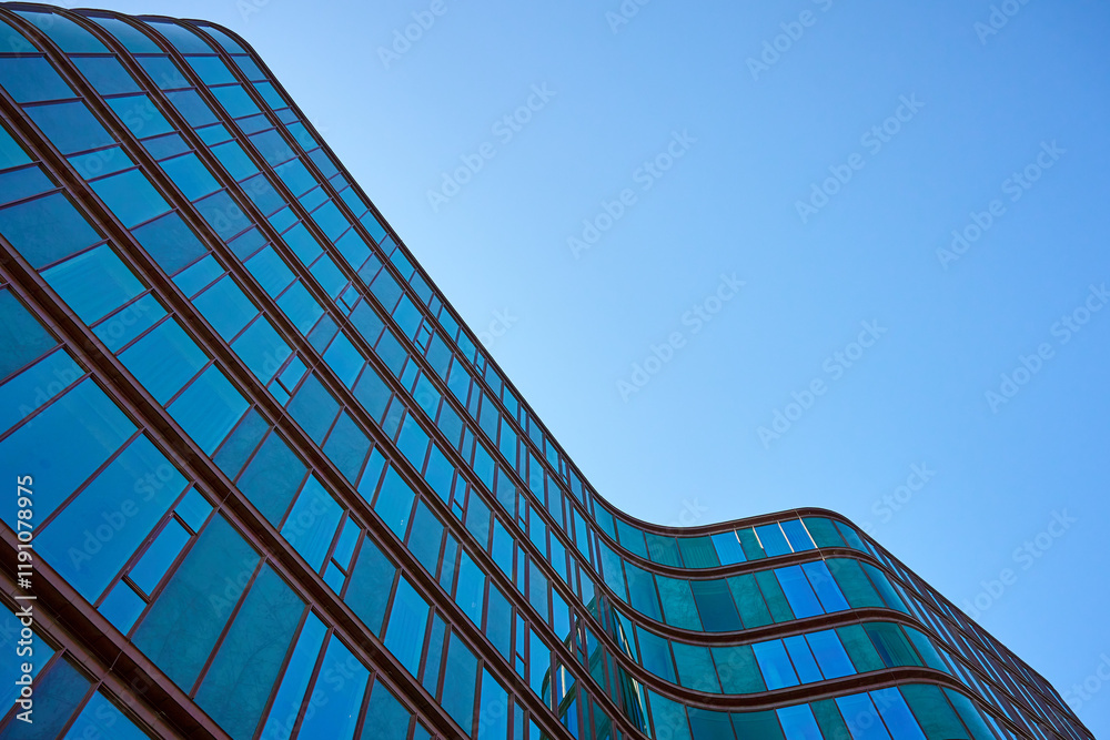 Low angle view of modern curved high rise building. Glass facade of ...