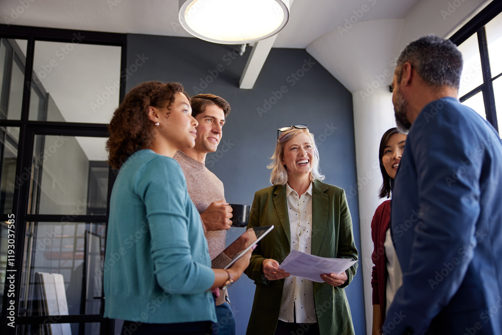Friendly multiethnic business team discussion during a casual meeting ...