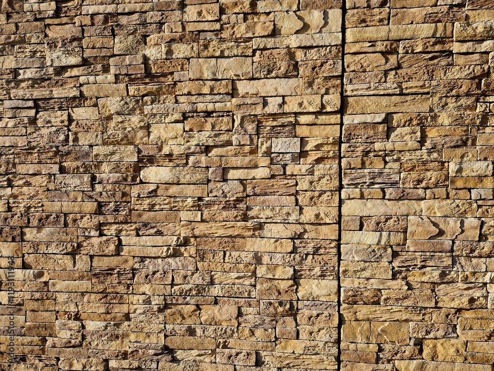 Modern gray brown, beige, metal door at the house lined with stone ...