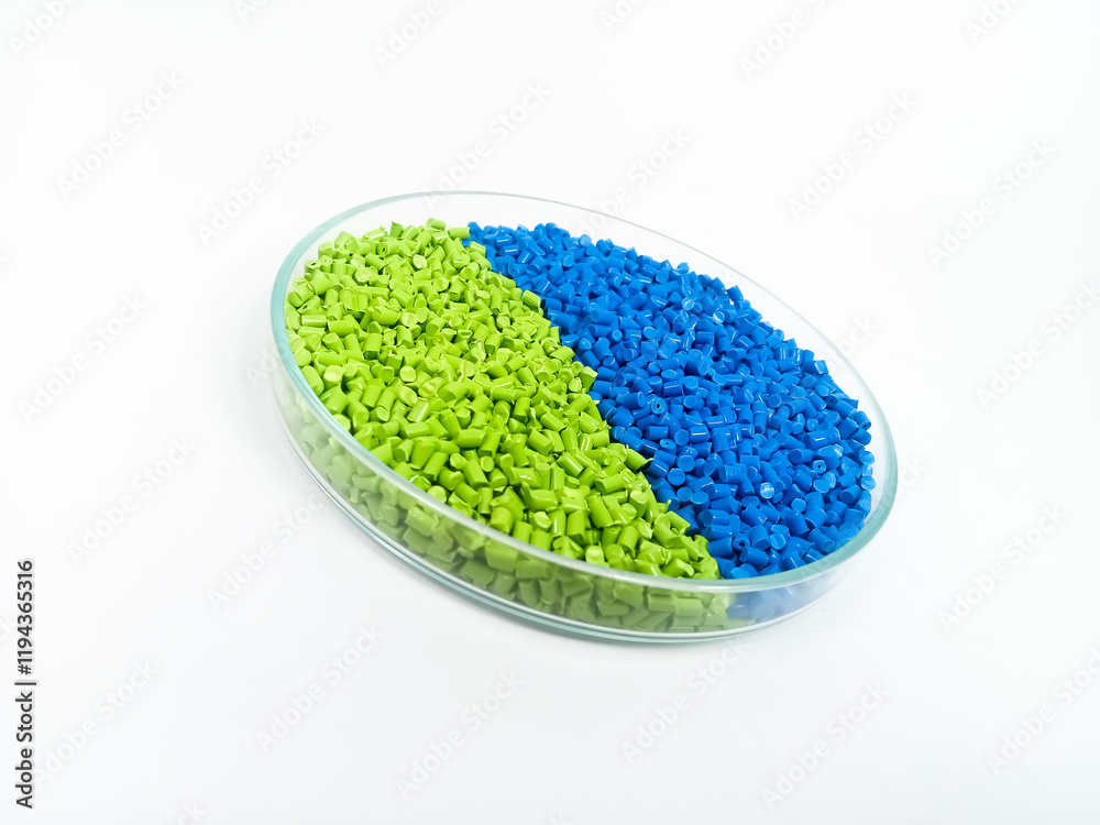 Colorful masterbatch plastic granules in transparent glass cup, polymer ...