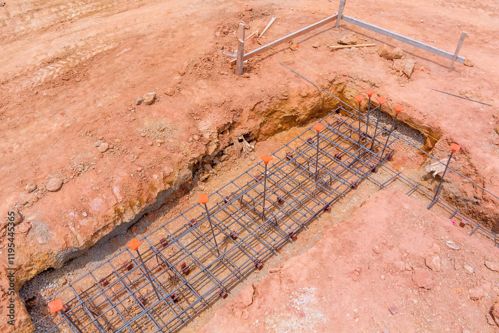 Construction workers prepare trench with reinforced rebar for ...
