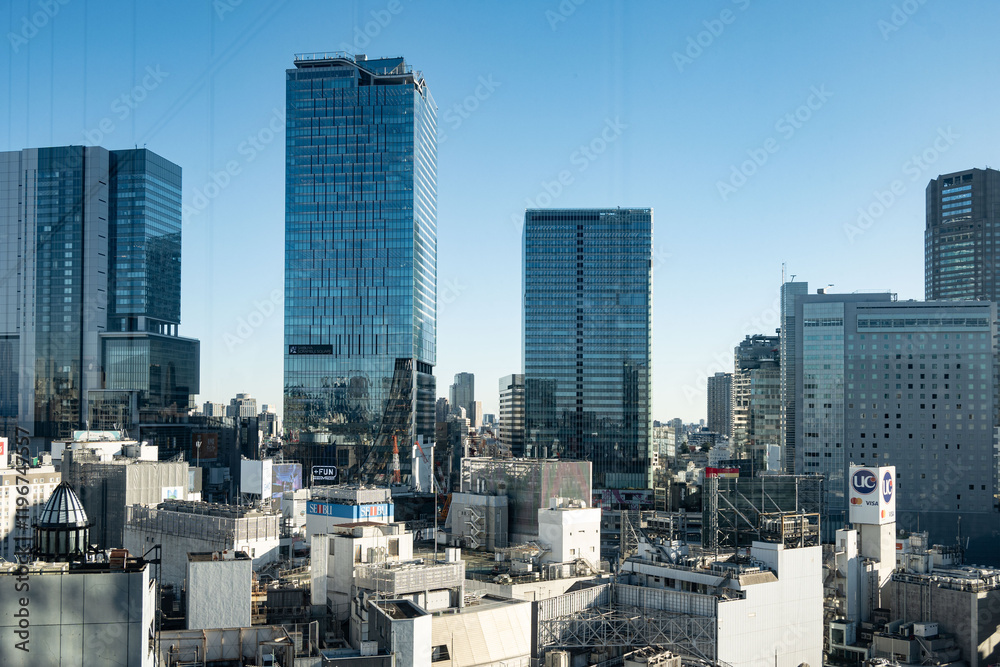 Tokyo city, Shibuya skyline with tall buildings and blue sky during ...