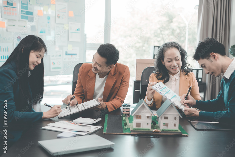 Real estate business meeting with wooden house models on documents ...