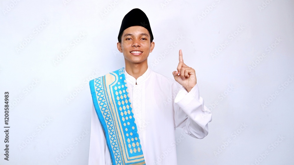 handsome asian muslim youth pose pointing up with isolated white ...