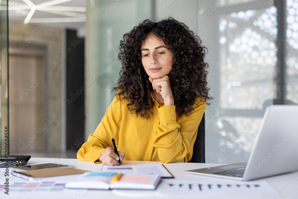 Serious focused woman doing paperwork inside office. Businesswoman ...