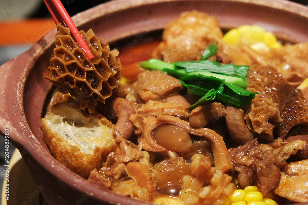 chopsticks picking beef tripe from ngau zap hot pot. Cantonese food ...