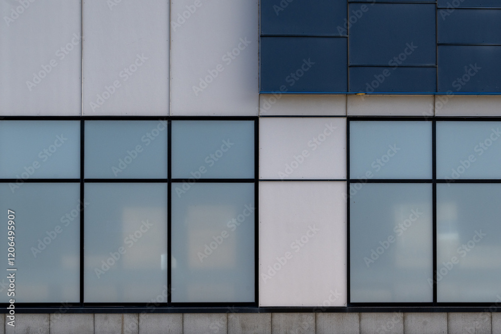 The exterior of a silver-grey metal panel skyscraper wall. The ...