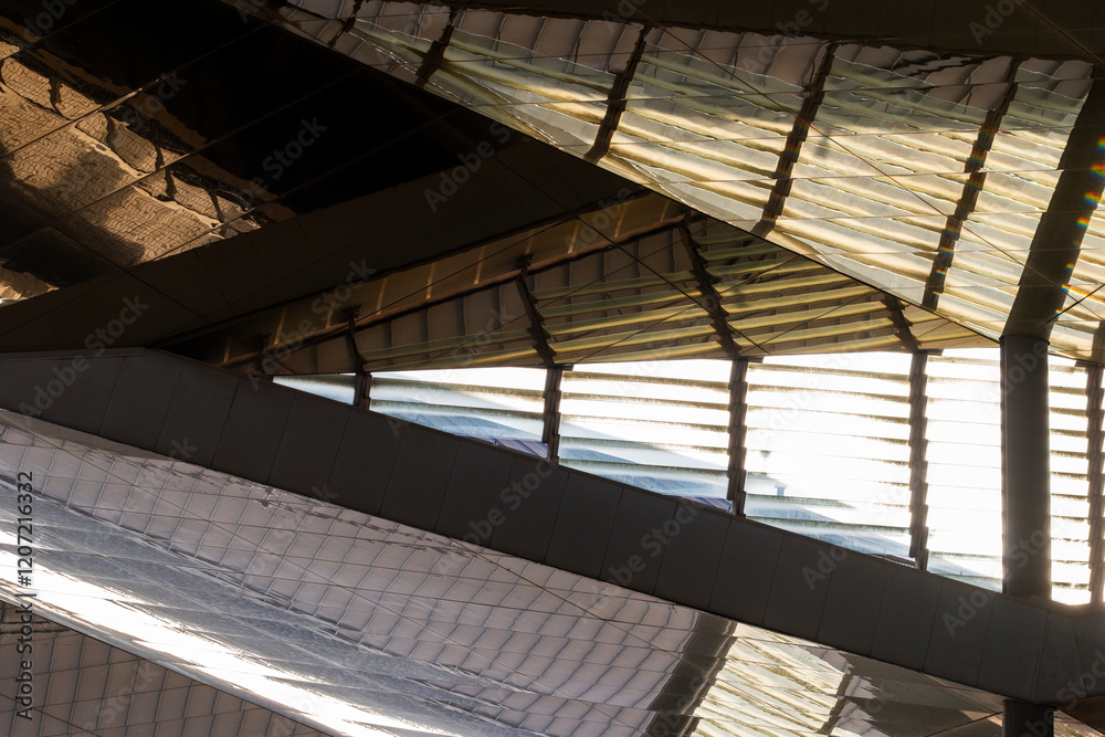 The image showcases an intricate architectural design where reflections and light interplay ...