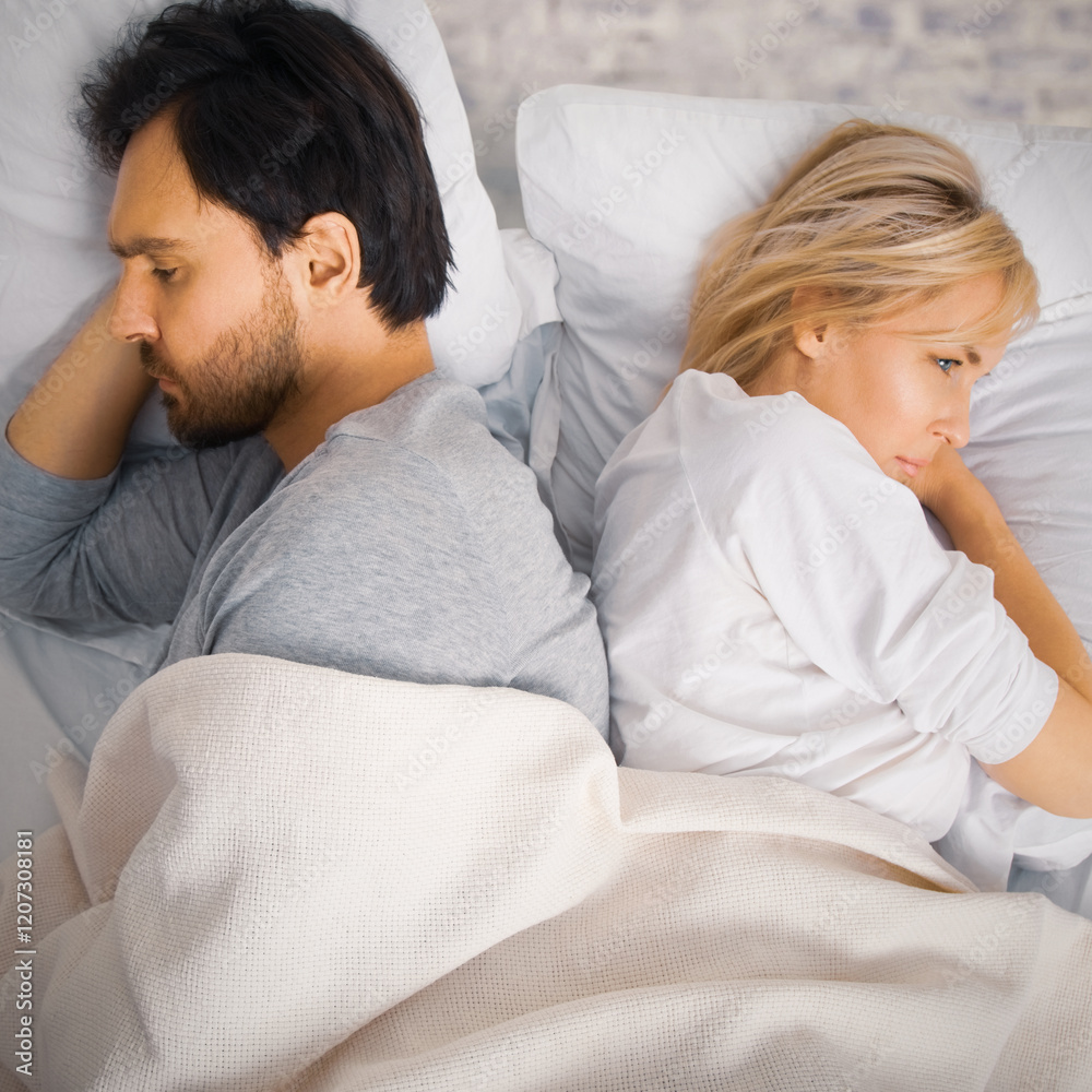 Unhappy sad couple, family beard man, woman, husband, wife lay in bed ...