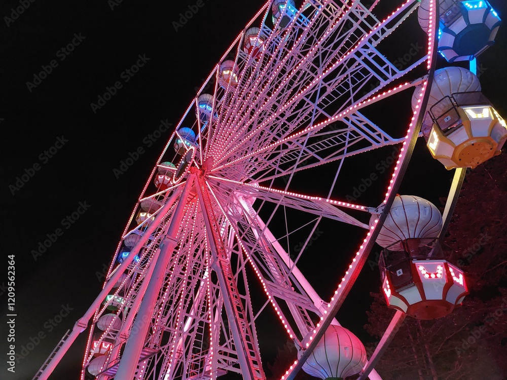 Ferris wheel dominates the frame, its white structure adorned with ...