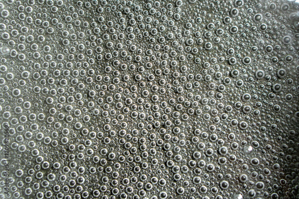 Clear water at the very beginning of the boiling process. A lot of ...