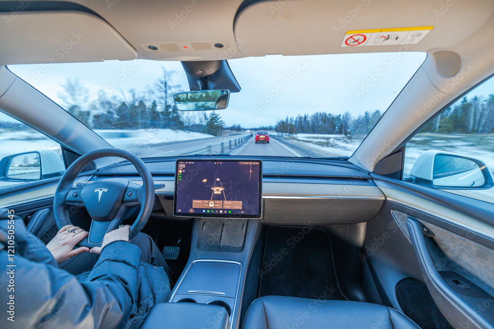Tesla Model Y interior view with autopilot engaged on snowy highway ...