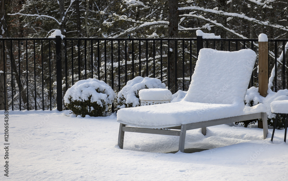 poolside lounge chairs covered in snow during winter (off season spa ...