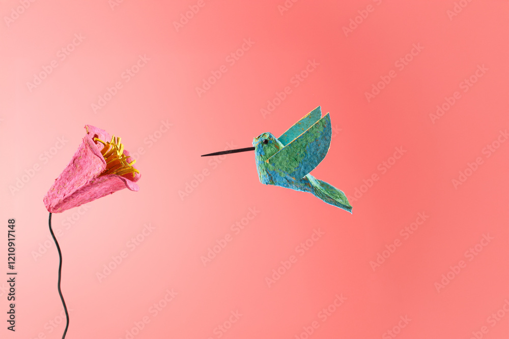 handcrafted paper sculpture of a hummingbird and a flower, step in ...