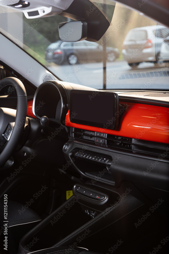A modern car interior featuring a red dashboard, touchscreen ...