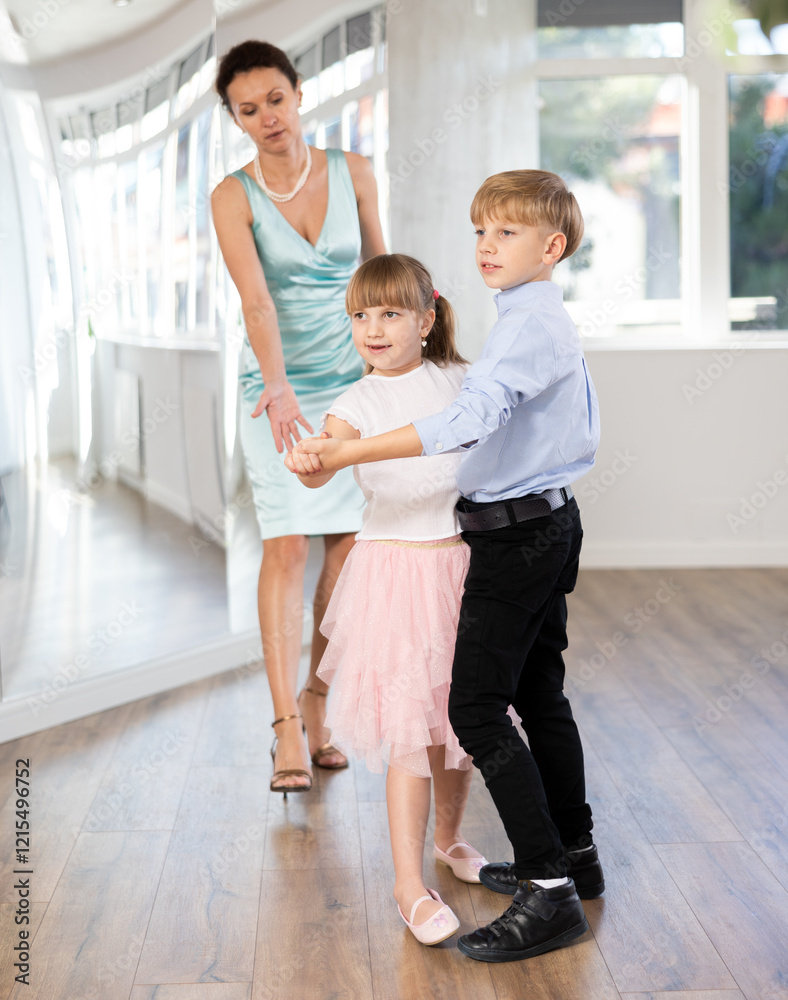 Boy paired up with girl during ballroom dancing lesson. Children ...