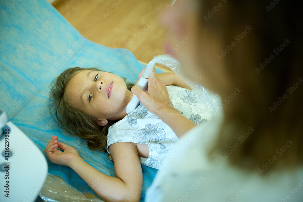 Close up of doctor making thyroid sonogram for kid. Pediatric ...