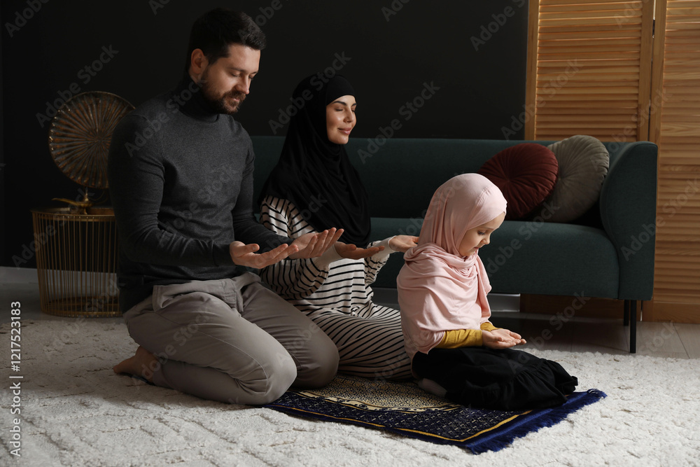 Muslim family praying on mat at home Stock Photo | Adobe Stock