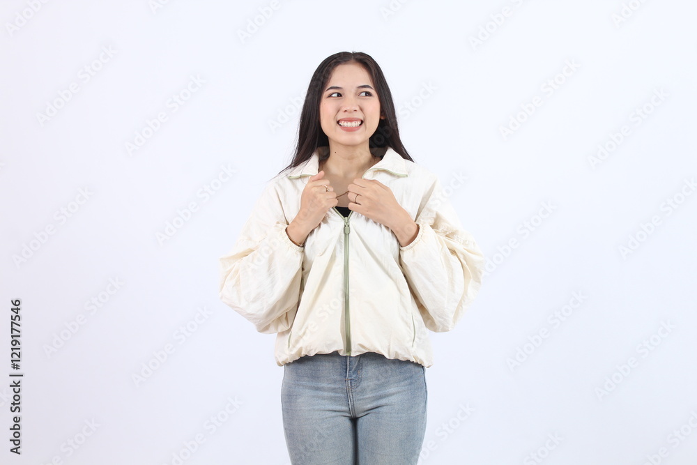 Asian girl feels hot and wants to take off her cream jacket to cool her ...