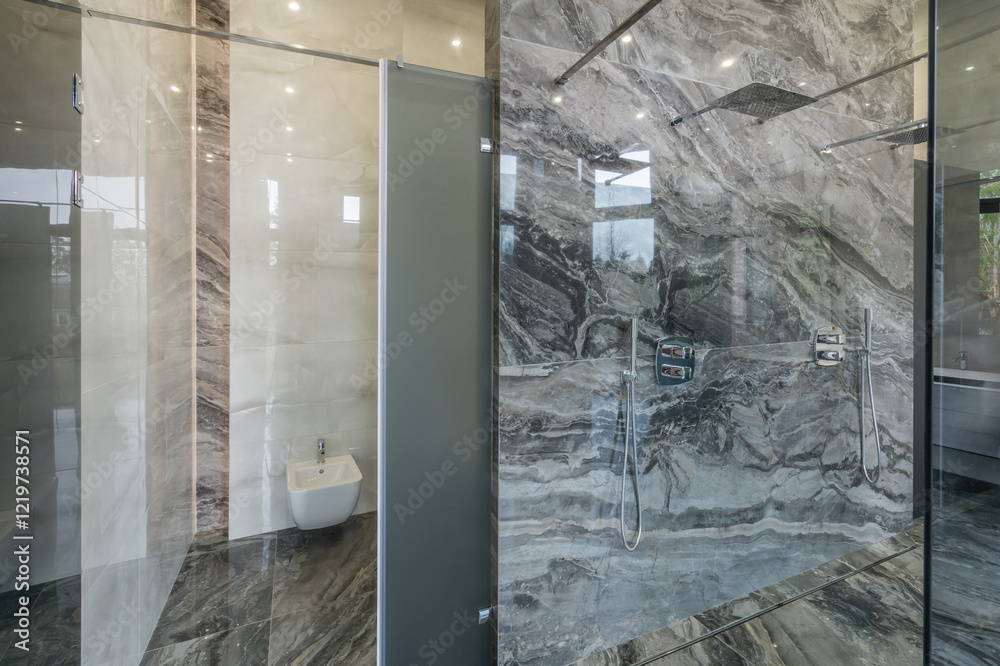Stylish interior design of the bathroom, decorated with marble tiles ...