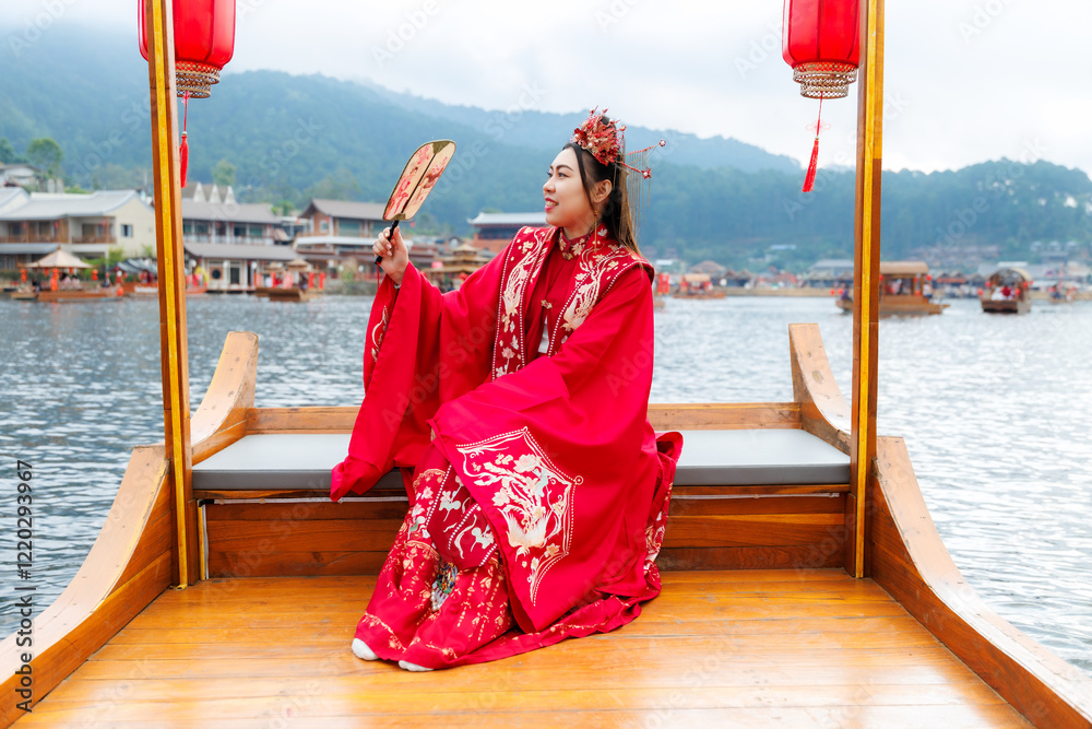 female wearing traditional red chinese dress on a raft in river at Rak ...