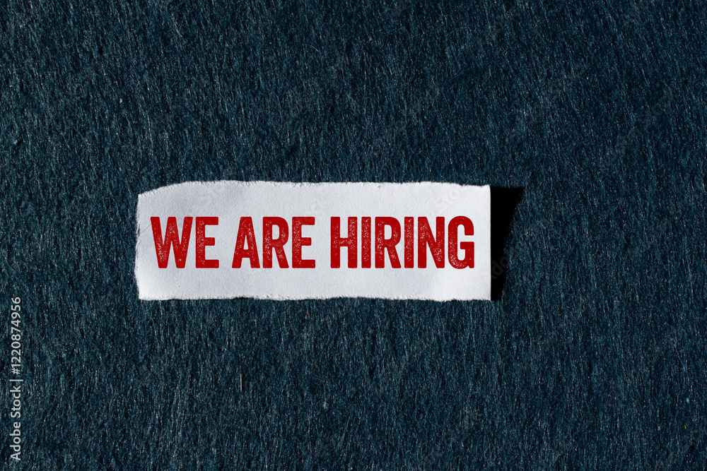 We are hiring message written on ripped torn paper piece with gray background. Conceptual we are ...