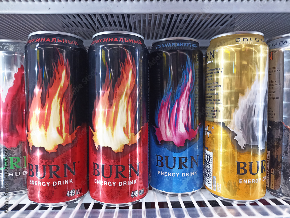 Foto de Stock Burn energy drink cans on store beverage shelf displaying ...