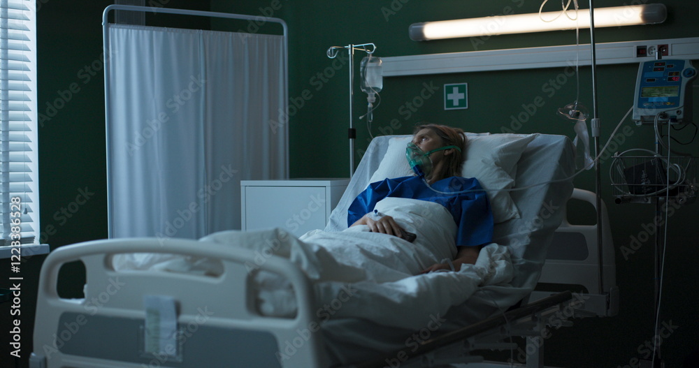 Aged patient in bed, watching funny videos on her phone, the oxygen ...