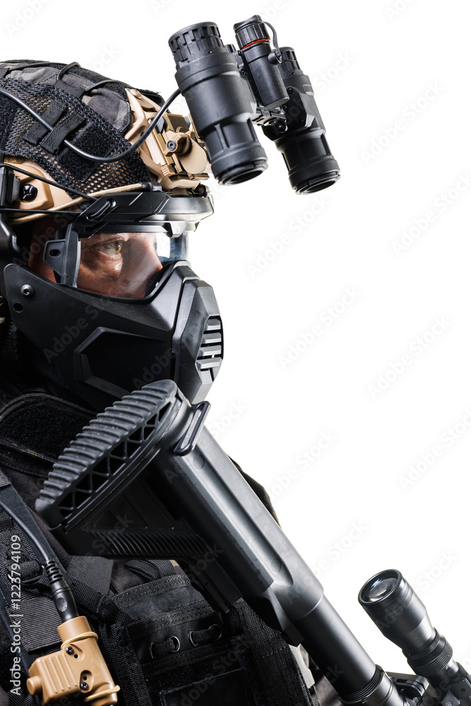 Modern tactical operator equipped with advanced combat gear and night ...