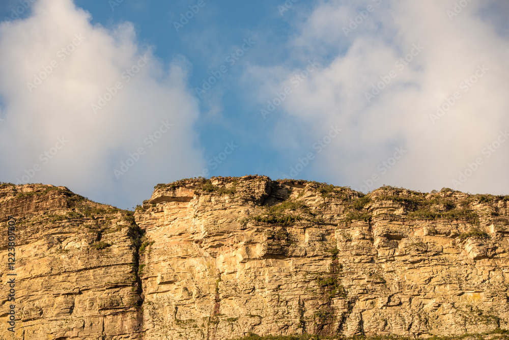 tall rock and detailed formations with a clear blue sky background in ...