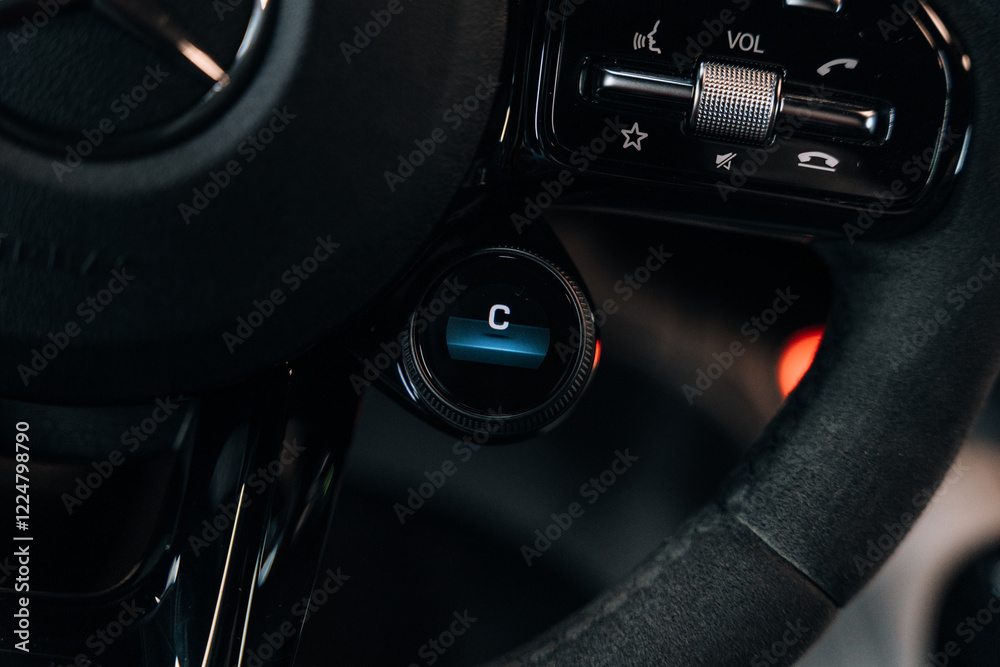 Detailed view of the AMG suspension mode selector on the steering wheel ...