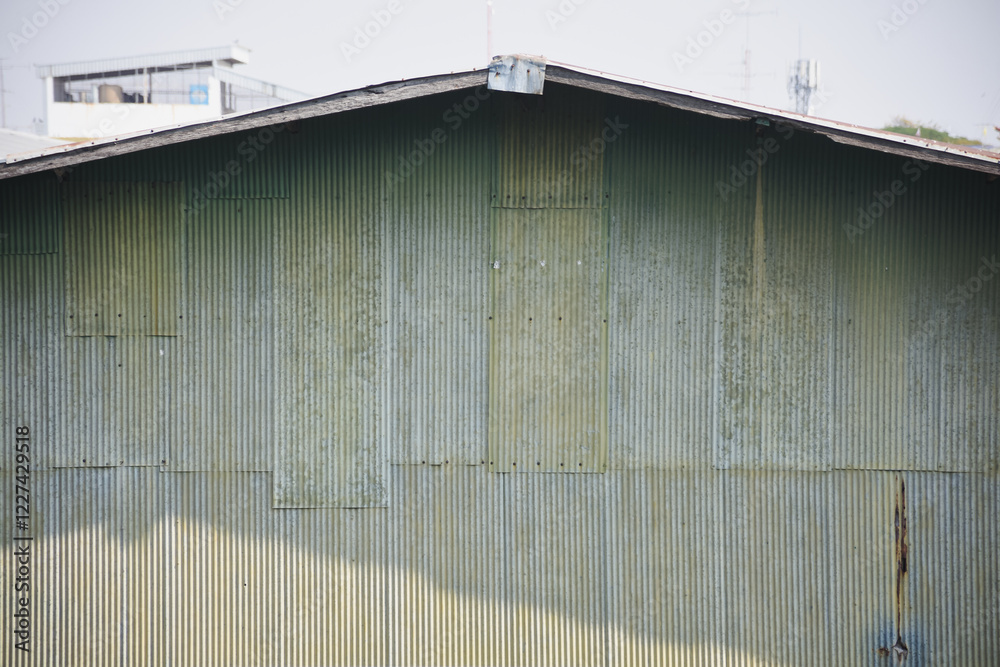 the side of a corrugated metal building. The building's wall is made up ...