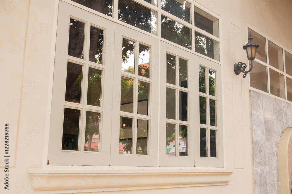 Cozy house exterior with wooden casement window and white wall ...