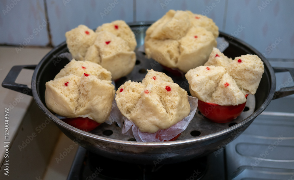 Steaming basket with Huat Kueh (Chinese prosperity cakes). Light yellow ...